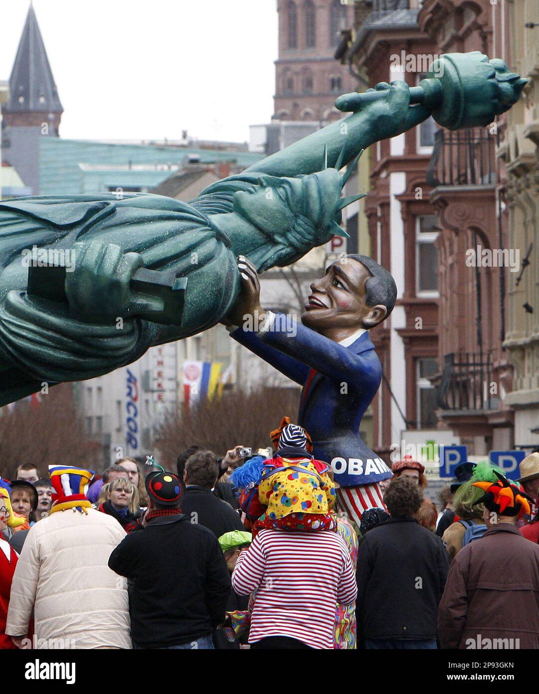 A carnival float caricaturing U.S. President Barack Obama lifting the ...