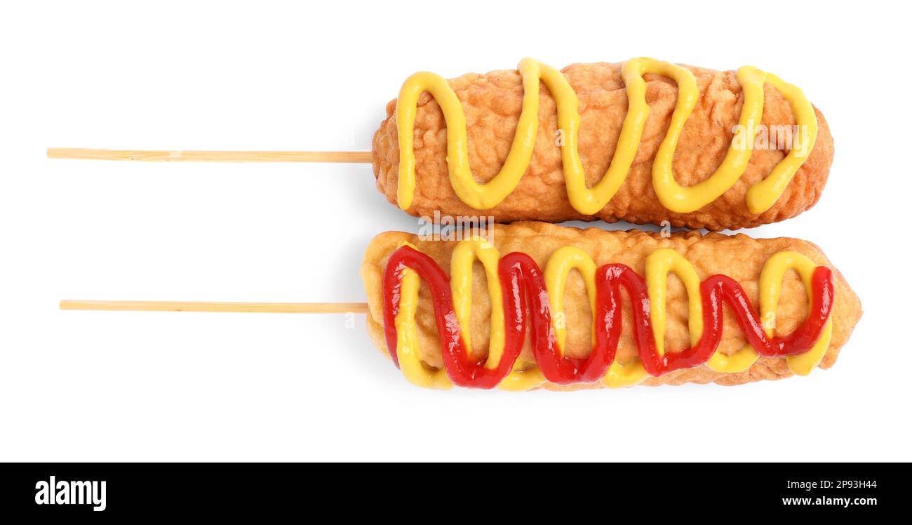 Delicious deep fried corn dogs with sauces on white background, top ...