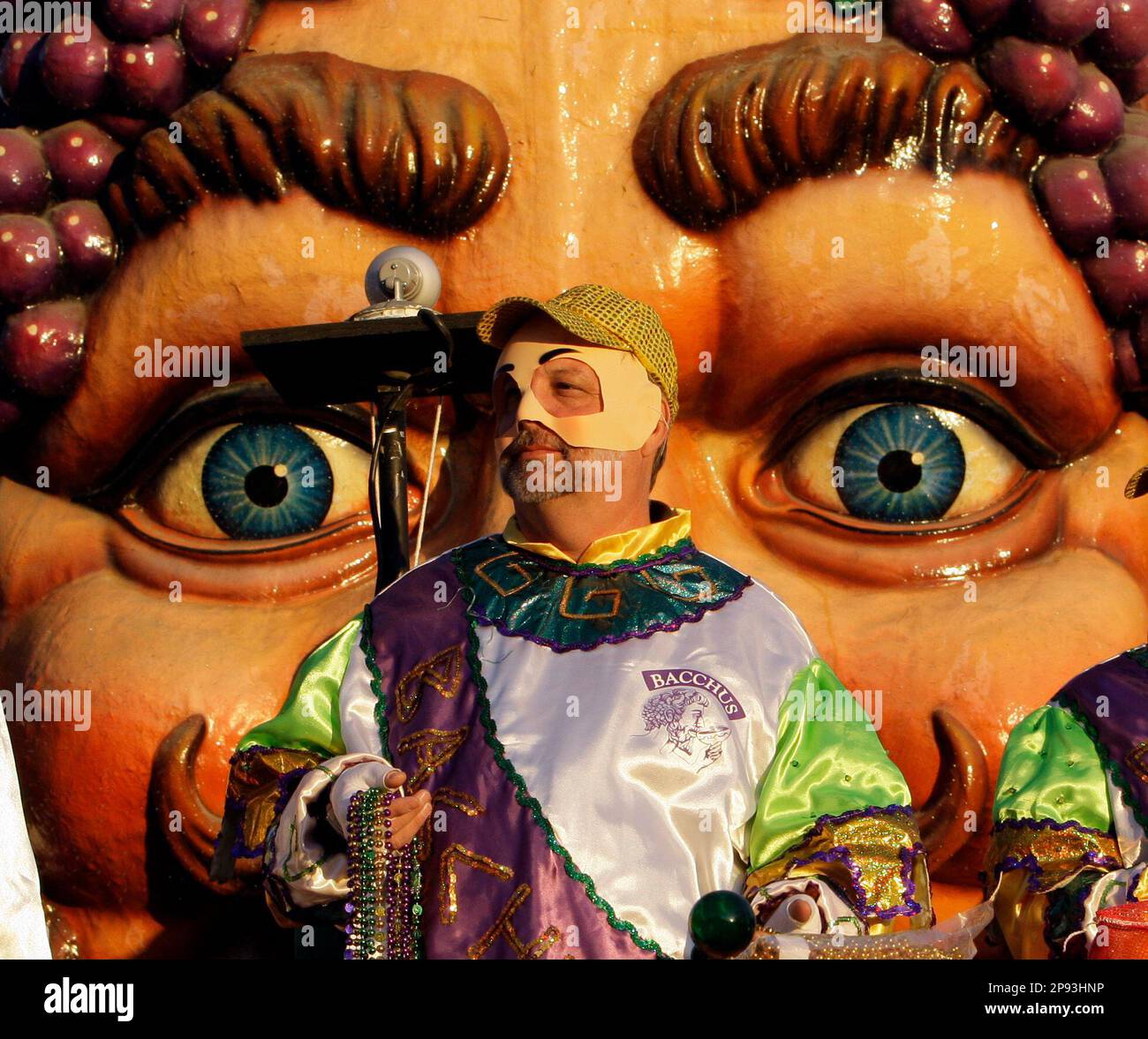 A rider looks to throw his beads during the Krewe of Bacchus parade in ...