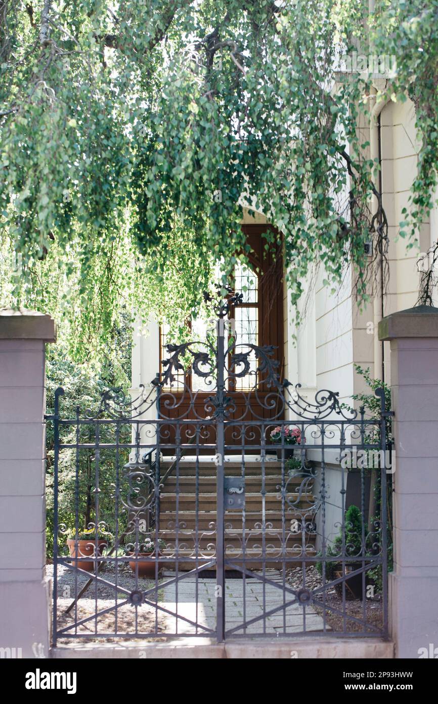 House entrance behind locked metal gate in Germany Stock Photo - Alamy