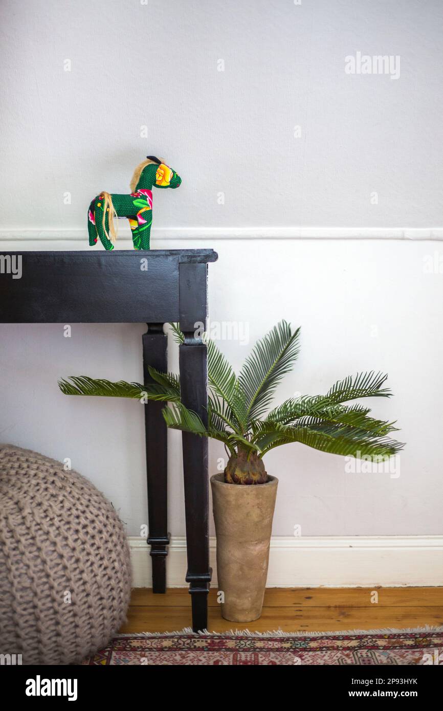 Indoor palm tree next to a small side table in an old building in ...