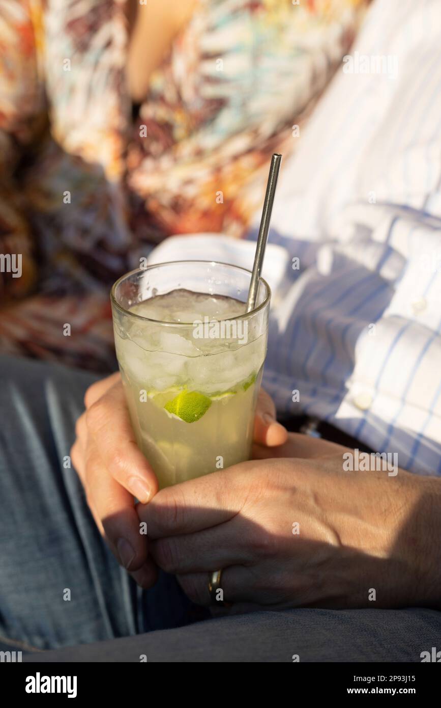 Man holding cocktail caipirinha in his hands Stock Photo - Alamy