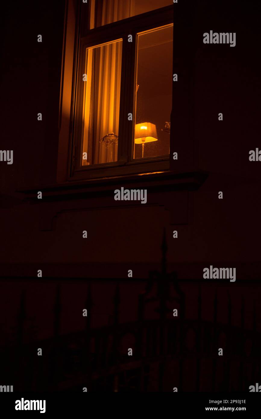 Sparsely lit window of a villa at night Stock Photo - Alamy