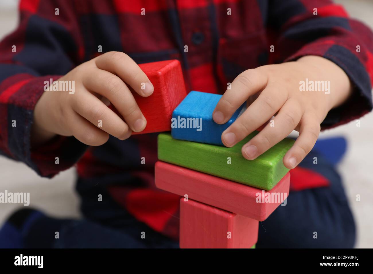 Little child playing with building blocks indoors, closeup Stock Photo ...