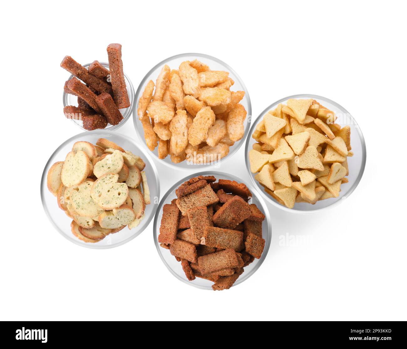 Different crispy rusks in bowls on white background, top view Stock ...