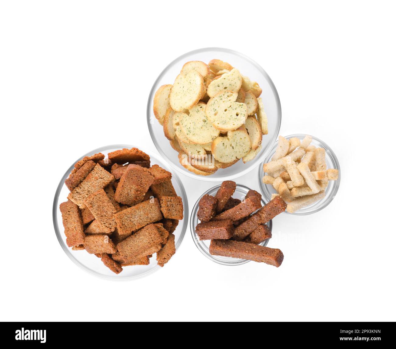 Different crispy rusks in bowls on white background, top view Stock ...