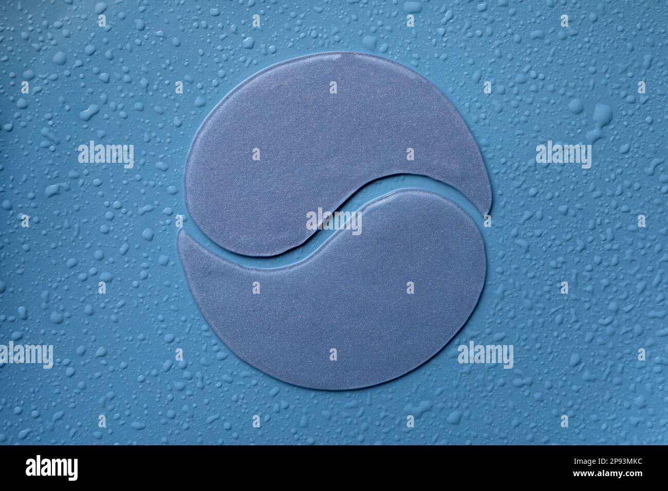 Under eye patches on blue wet background, flat lay. Cosmetic product ...