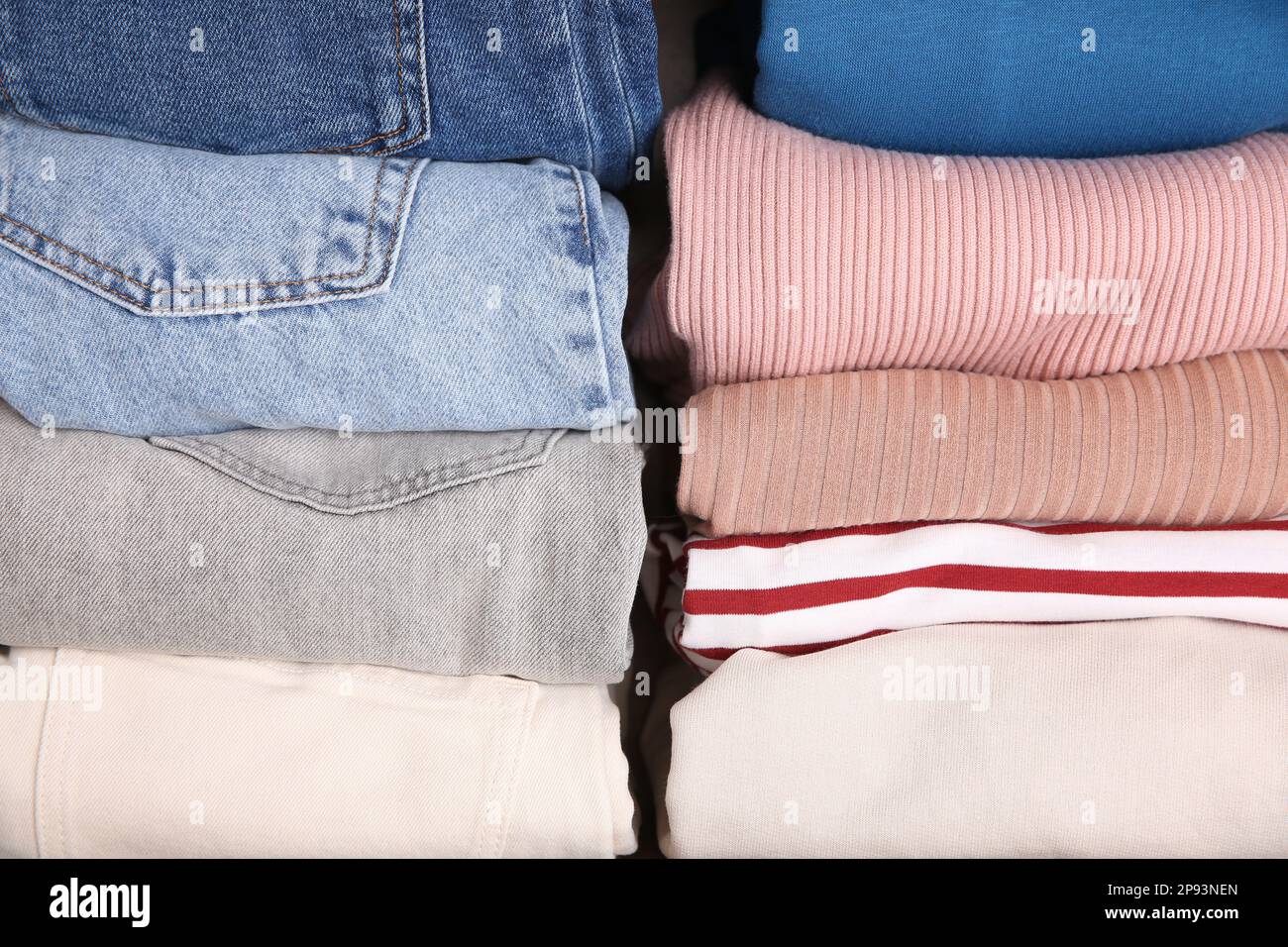Different folded clothes as background, top view. Vertical storage of ...