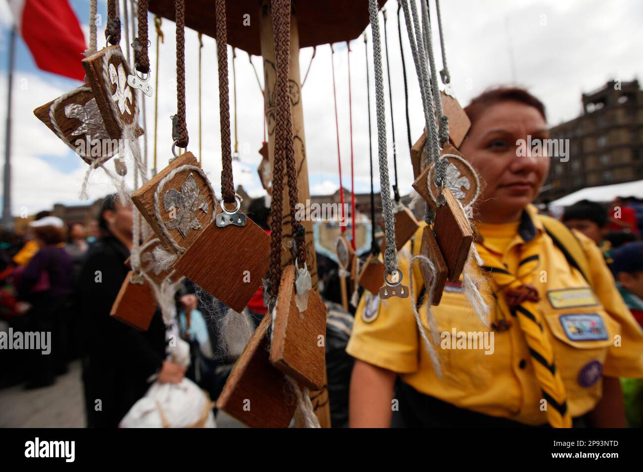 A Mexican scout leader stands behind images of the fleur de lis during ...