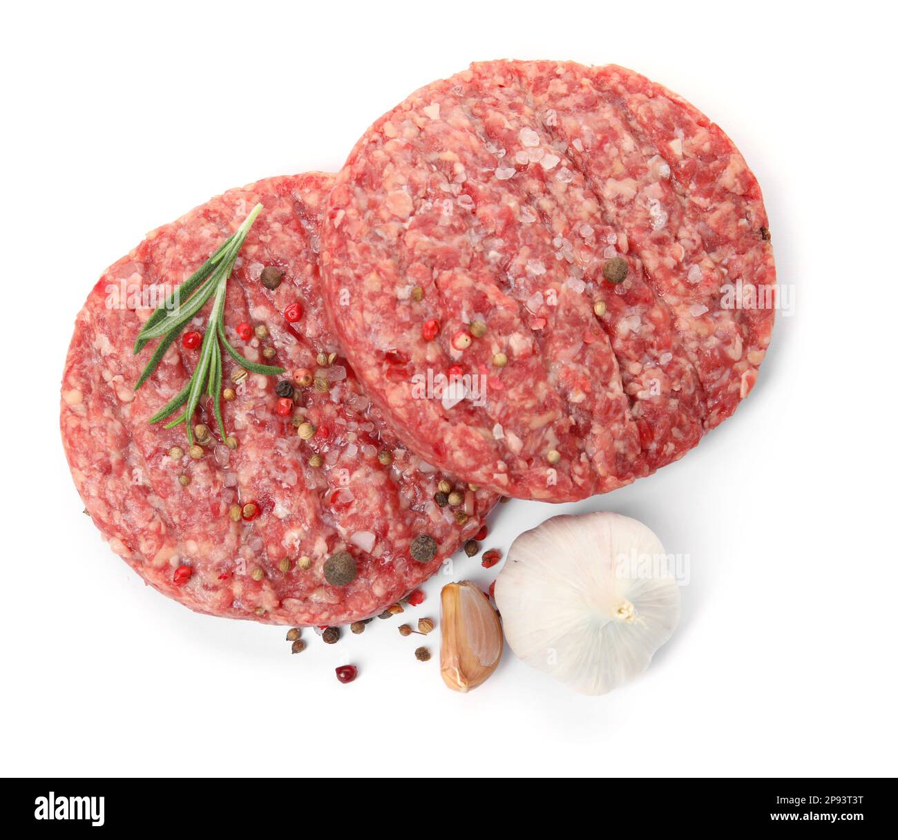 Raw hamburger patties with rosemary, garlic and spices on white ...