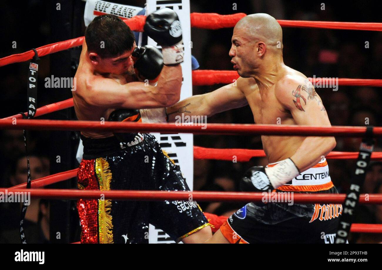 Miguel Cotto, right, of Puerto Rico, lands a punch against Michael ...