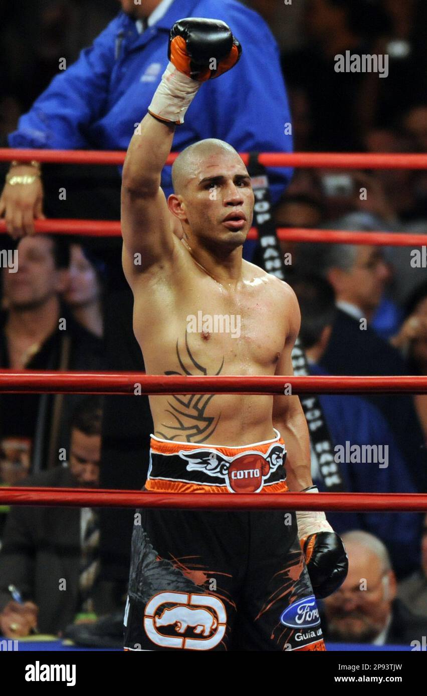 Miguel Cotto, of Puerto Rico, celebrates after beating Michael Jennings ...