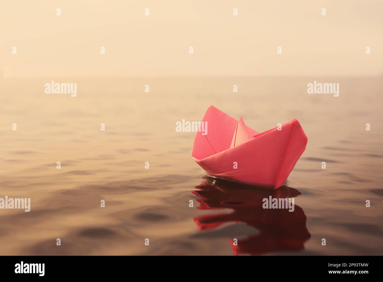 Pink paper boat floating on river. Retro photo effect Stock Photo - Alamy