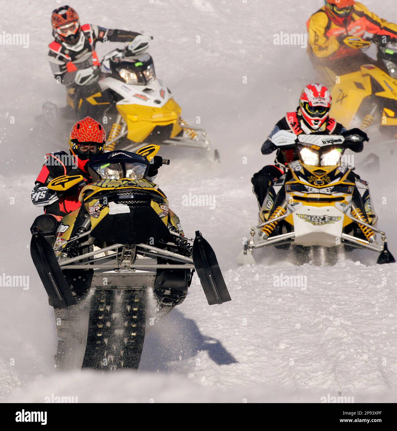 Snowmobile drivers race during the Rock Maple Racing Snocross series in ...