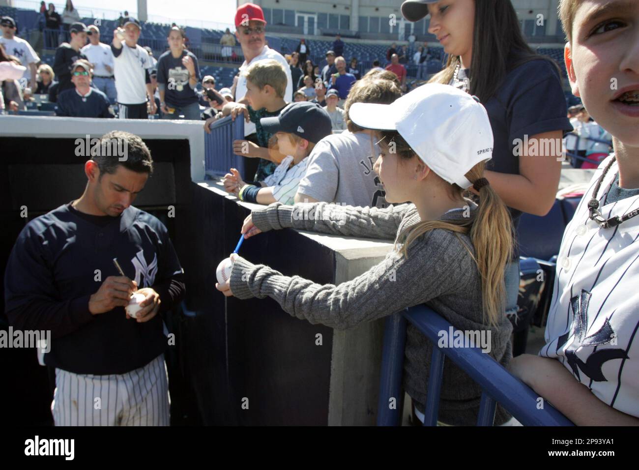 New York Yankees Jorge Posada signs autographs for fans after practice ...