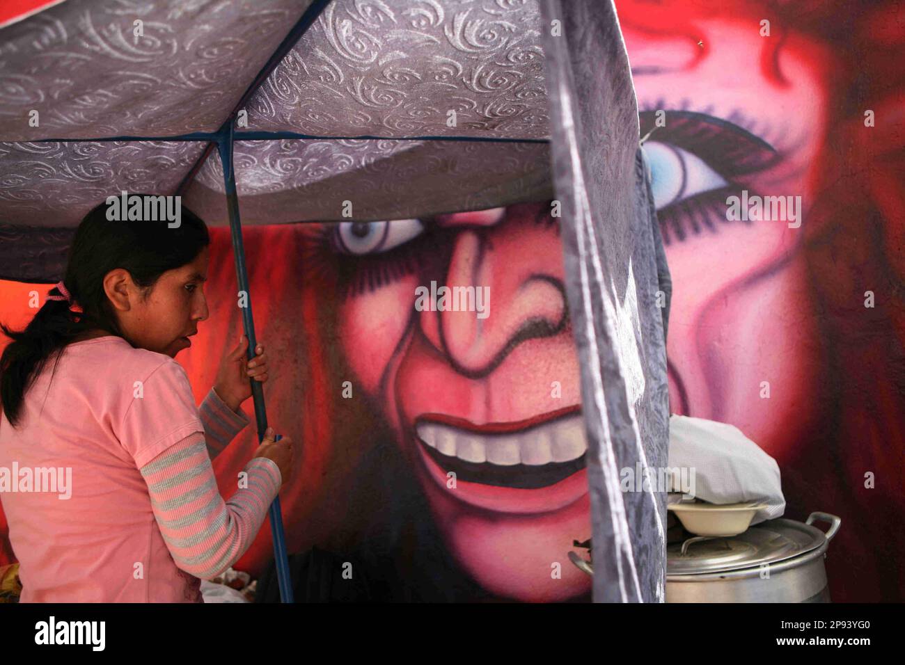 A street vendor sets her food stall during carnival celebrations in the ...