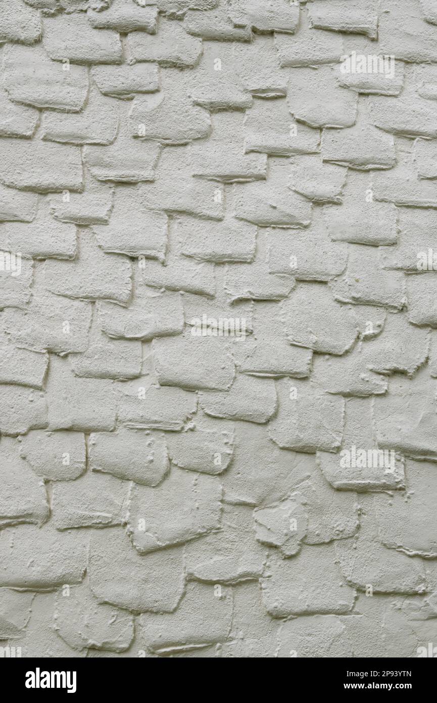 Concrete render creating a pattern on the wall of an old clay lump ...