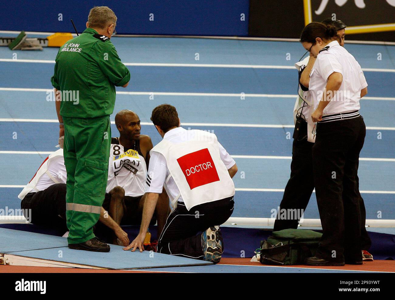 Bernard Lagat of the United States is treated by medics after competing ...