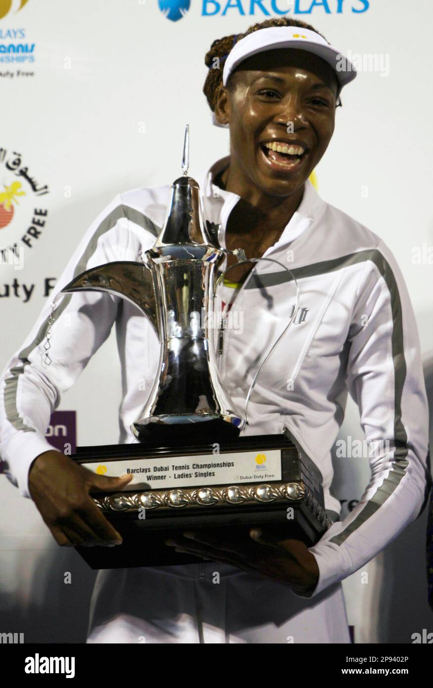 Venus Williams from the U.S. holds the trophy after defeating France's ...