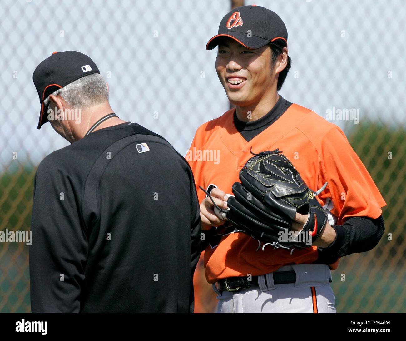 Baltimore Orioles starting pitcher Koji Uehara, right, laughs as he ...