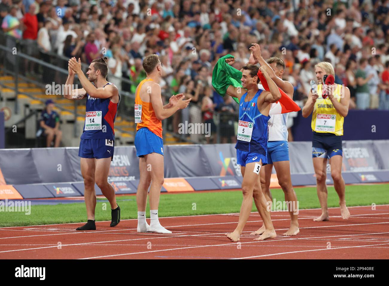 Decathletes walking across the track at the end of the decathlon at the ...