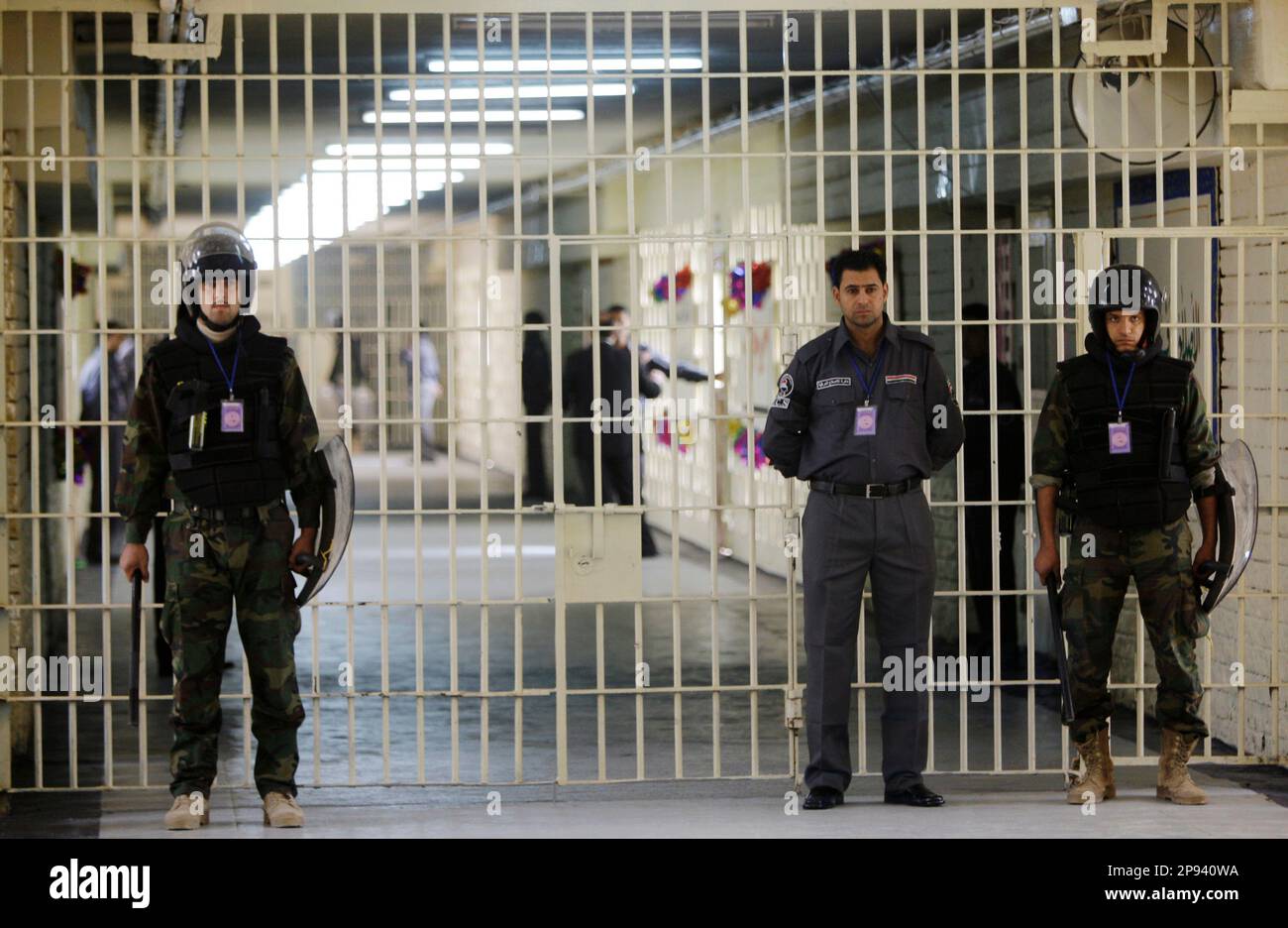 Guards stand at a cell block at the renovated Abu Ghraib prison, now ...