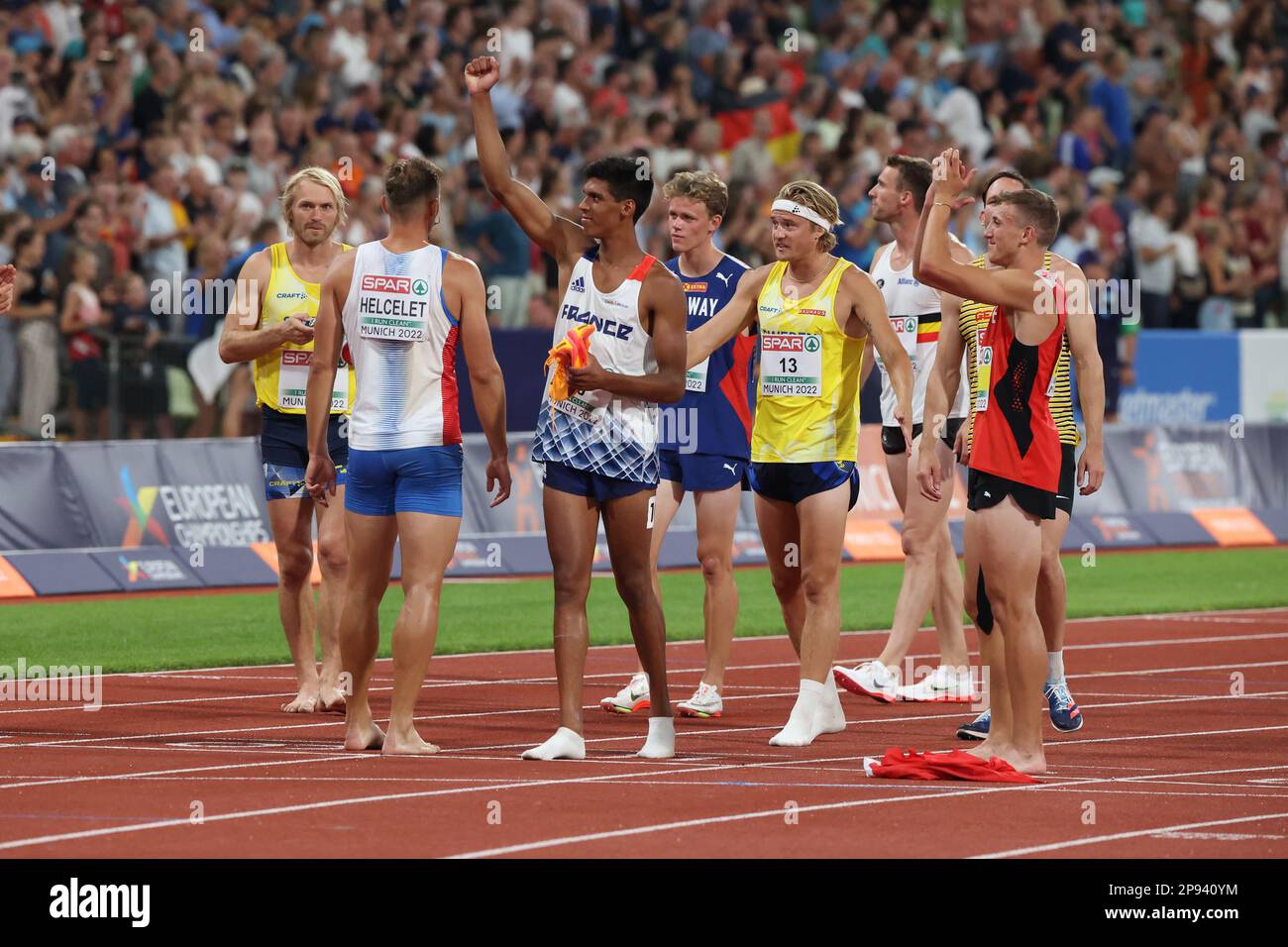 Decathletes walking across the track at the end of the decathlon at the ...