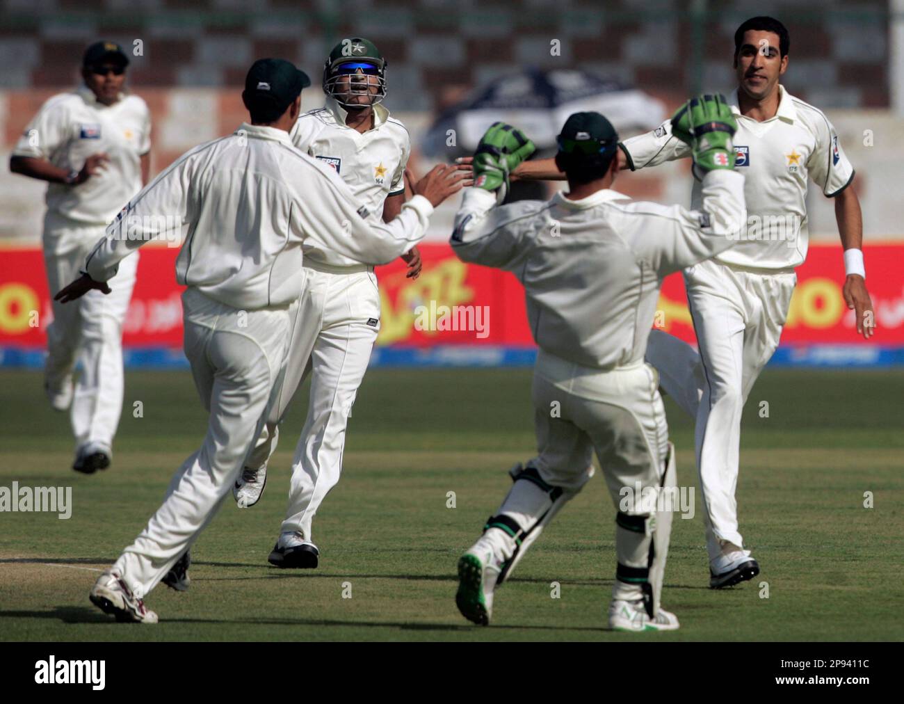 Pakistani players greet Umer Gul, right, for dismissing Sri Lankan ...