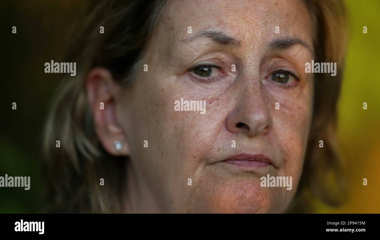 Close up face of a senior woman with pensive expression. Thoughtful ...