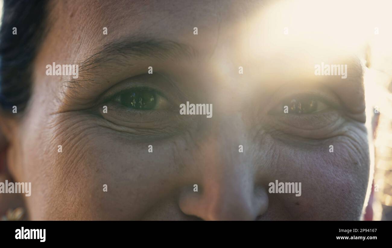 Extreme close up of a woman in her 40s eyes turning head to camera with ...