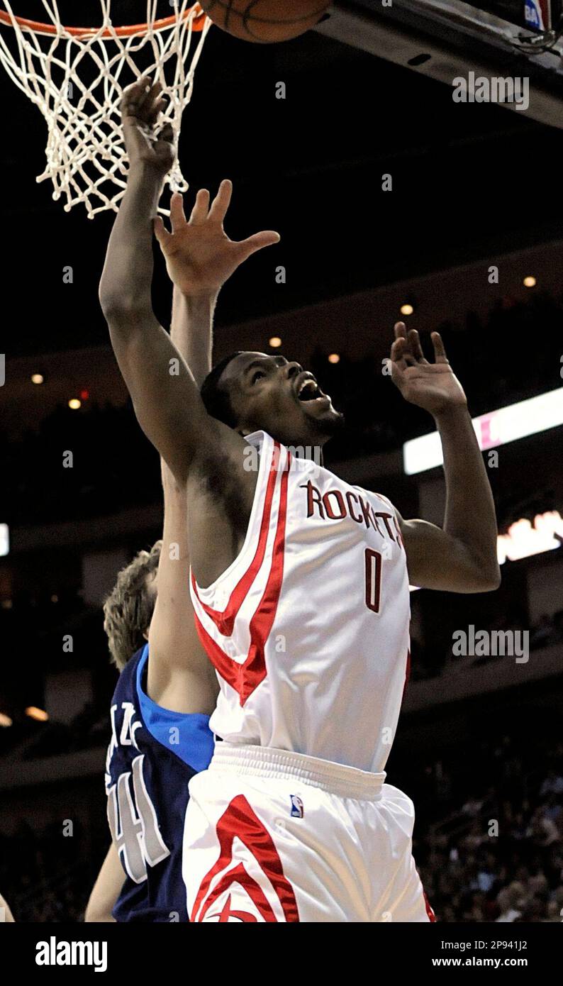 Houston Rockets' Aaron Brooks (0) is fouled by Dallas Mavericks' Dirk ...