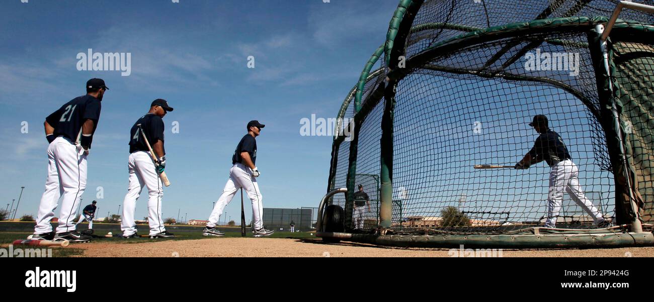 Seattle Mariners catcher Jeff Clement, right, watches his ball while ...
