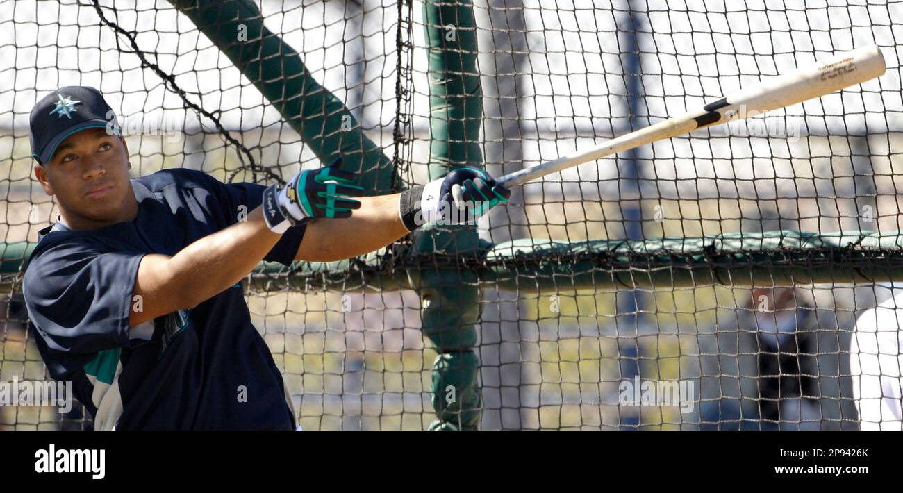 Seattle Mariners infielder Jose Lopez bats during spring training ...