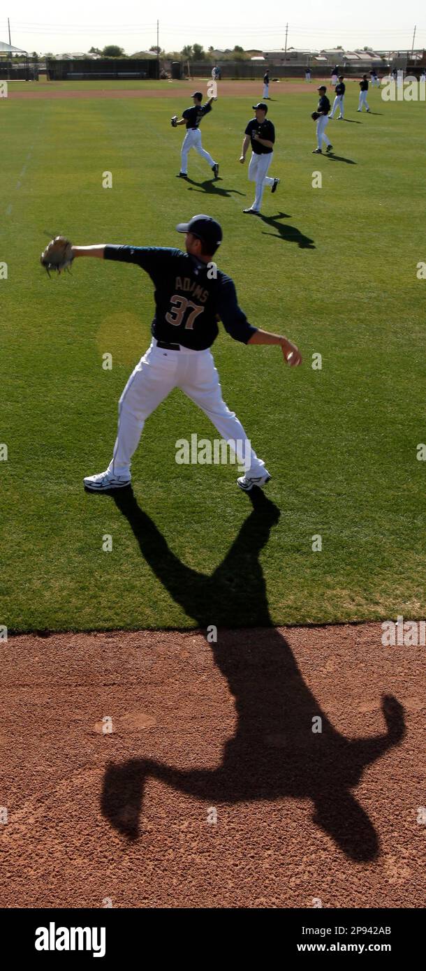 San Diego Padres pitcher Mike Adams, foreground, throws with other ...