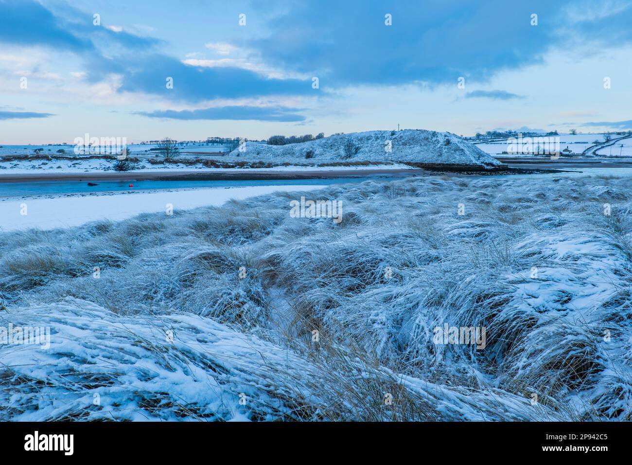 England, Northumberland, Alnmouth. Snow covered sand dunes near the ...