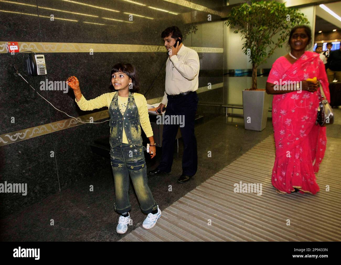 Rubina Ali Qureshi, 9, left, waves to her relatives as Shamim Begum, right, mother of Azharuddin ...
