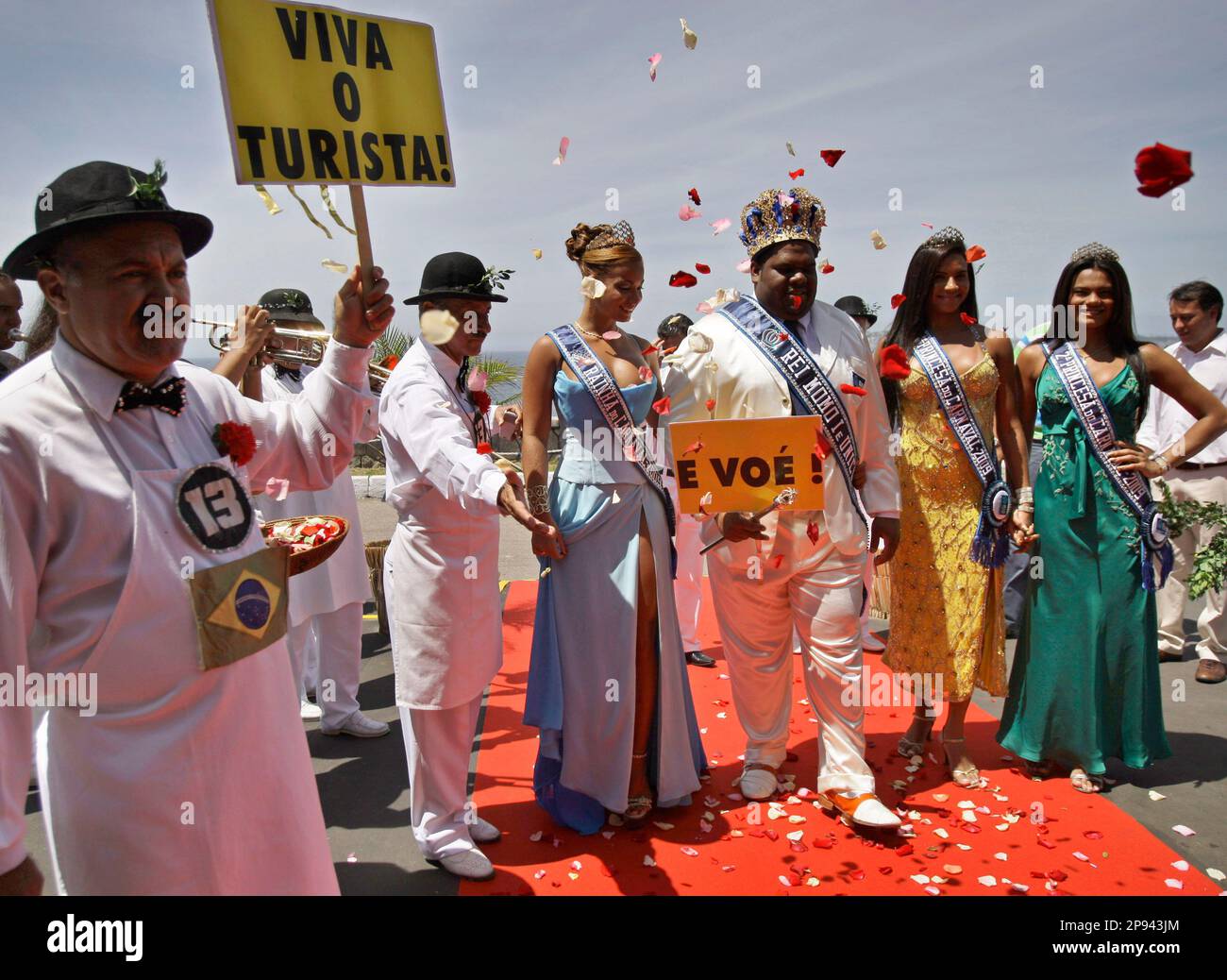 The Rei Momo, or Carnival King, center, walks with the Carnival Queen ...