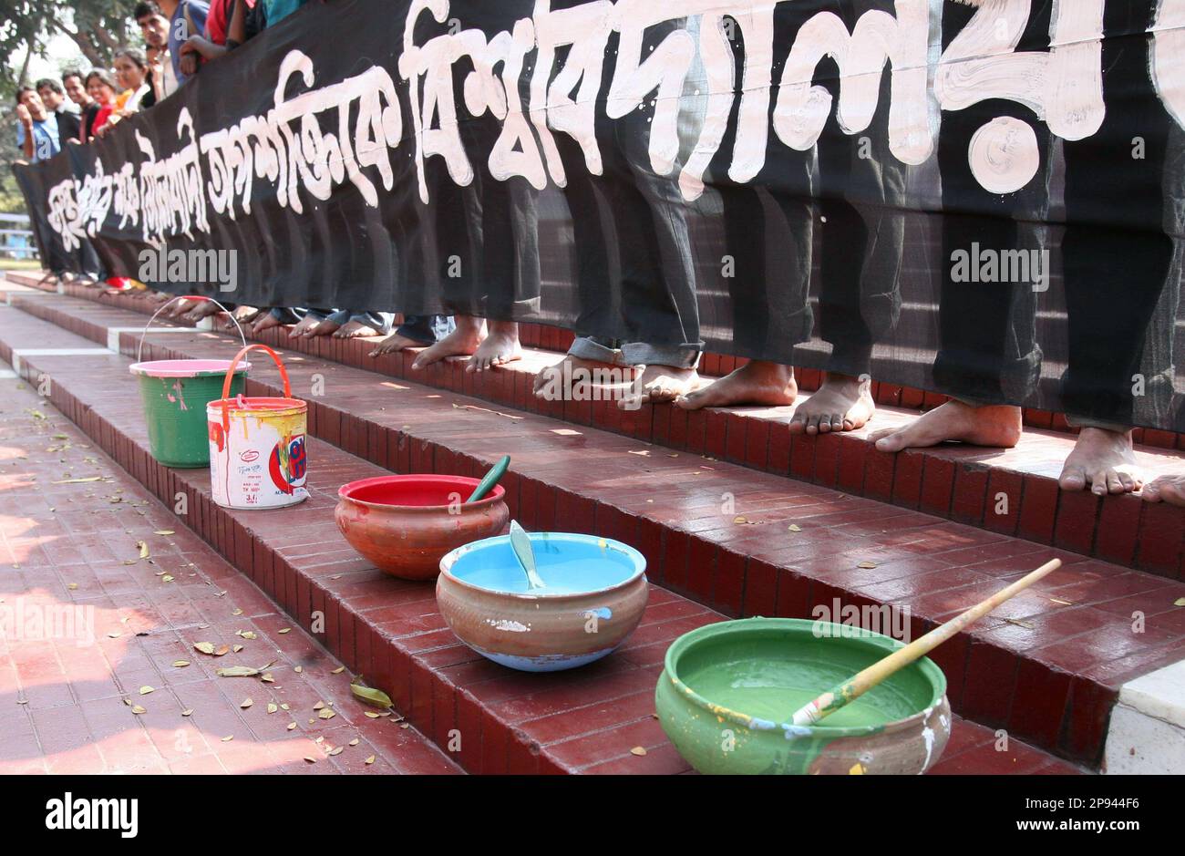 A group of Dhaka university students hold a banner during a protest ...