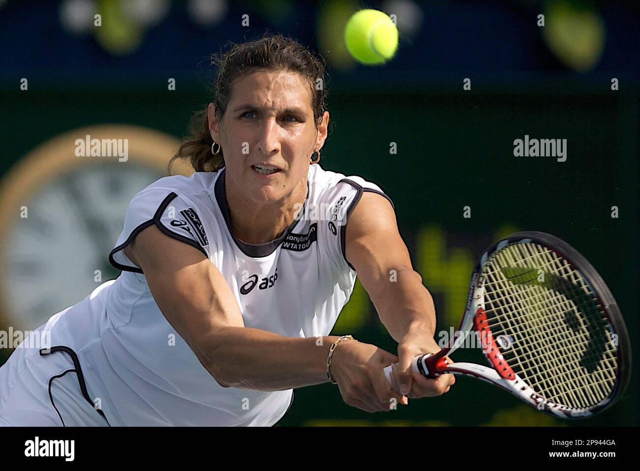 France's Virginie Razzano returns the ball to Kaia Kanepi of Estonia ...