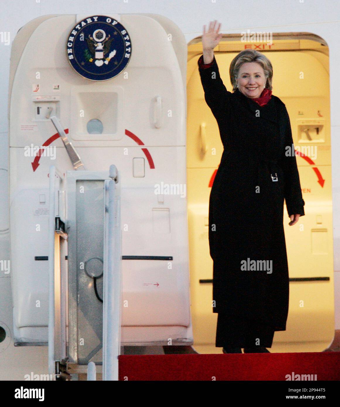 U.S. Secretary of State Hillary Rodham Clinton waves before leaving for ...