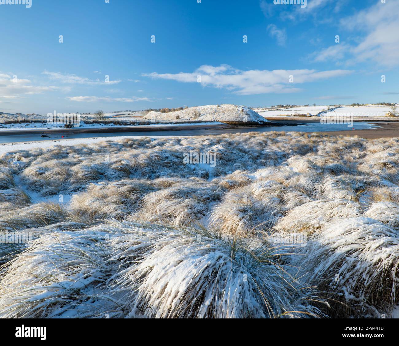 England, Northumberland, Alnmouth. Snow covered sand dunes near the ...