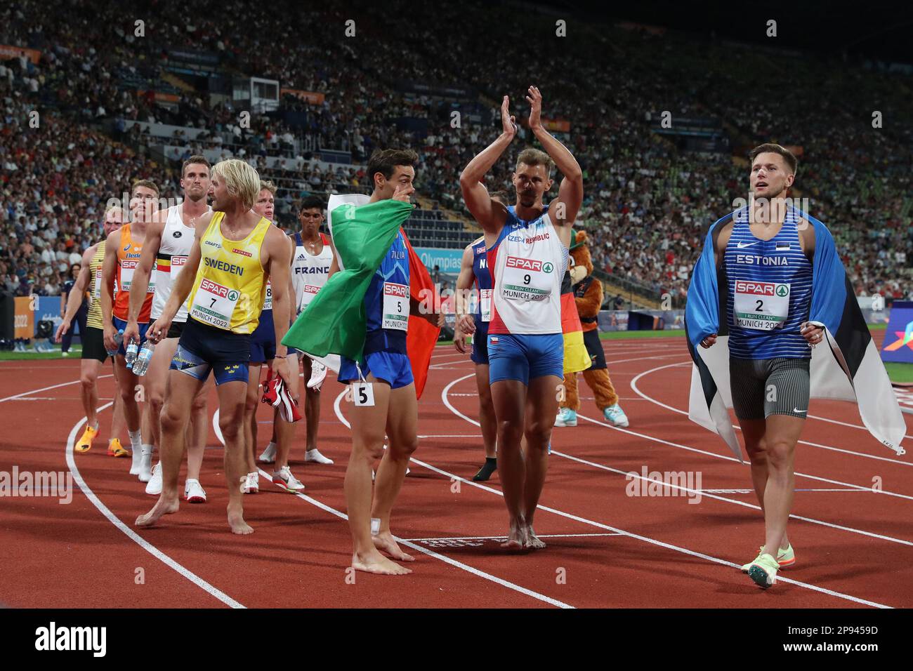 Decathletes walking across the track at the end of the decathlon at the ...