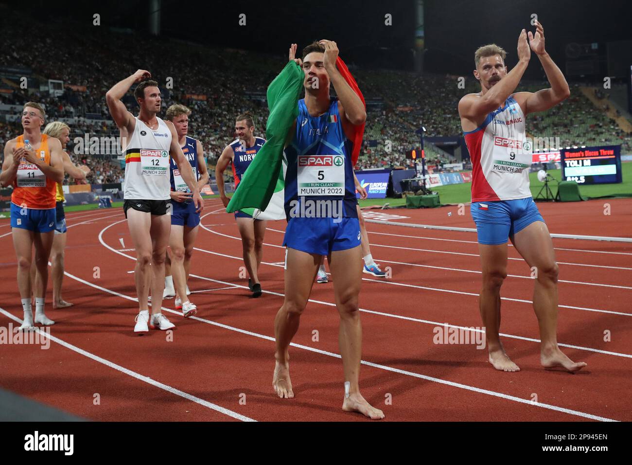Decathletes walking across the track at the end of the decathlon at the ...