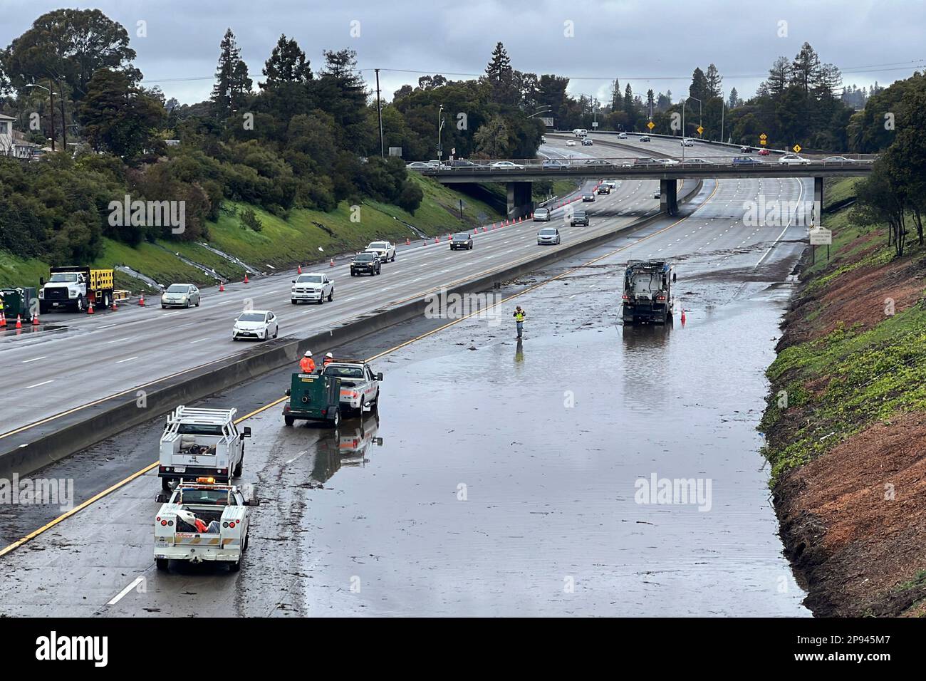 Caltrans crews work by a flooded section of Interstate 580 in Oakland, Calif., Friday, March 10 ...