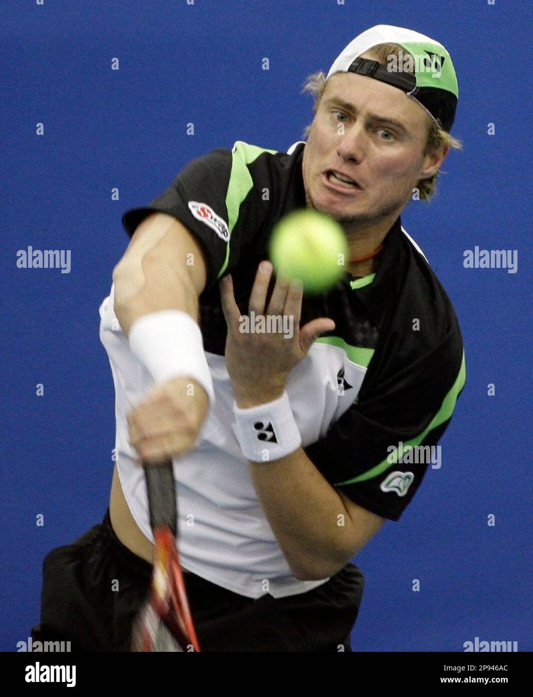 Lleyton Hewitt, of Australia, returns a shot to Chris Guccione at the ...