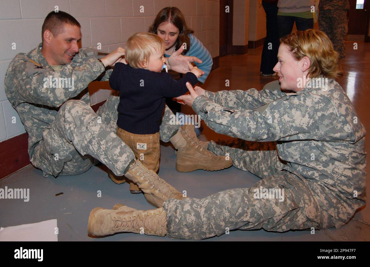 Dan and Lindsey Schauer play with their 10-month-old son, Logan, as Dan ...