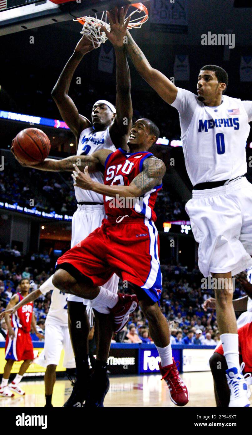 SMU guard Paul McCoy (23) drives between Memphis defenders Robert ...