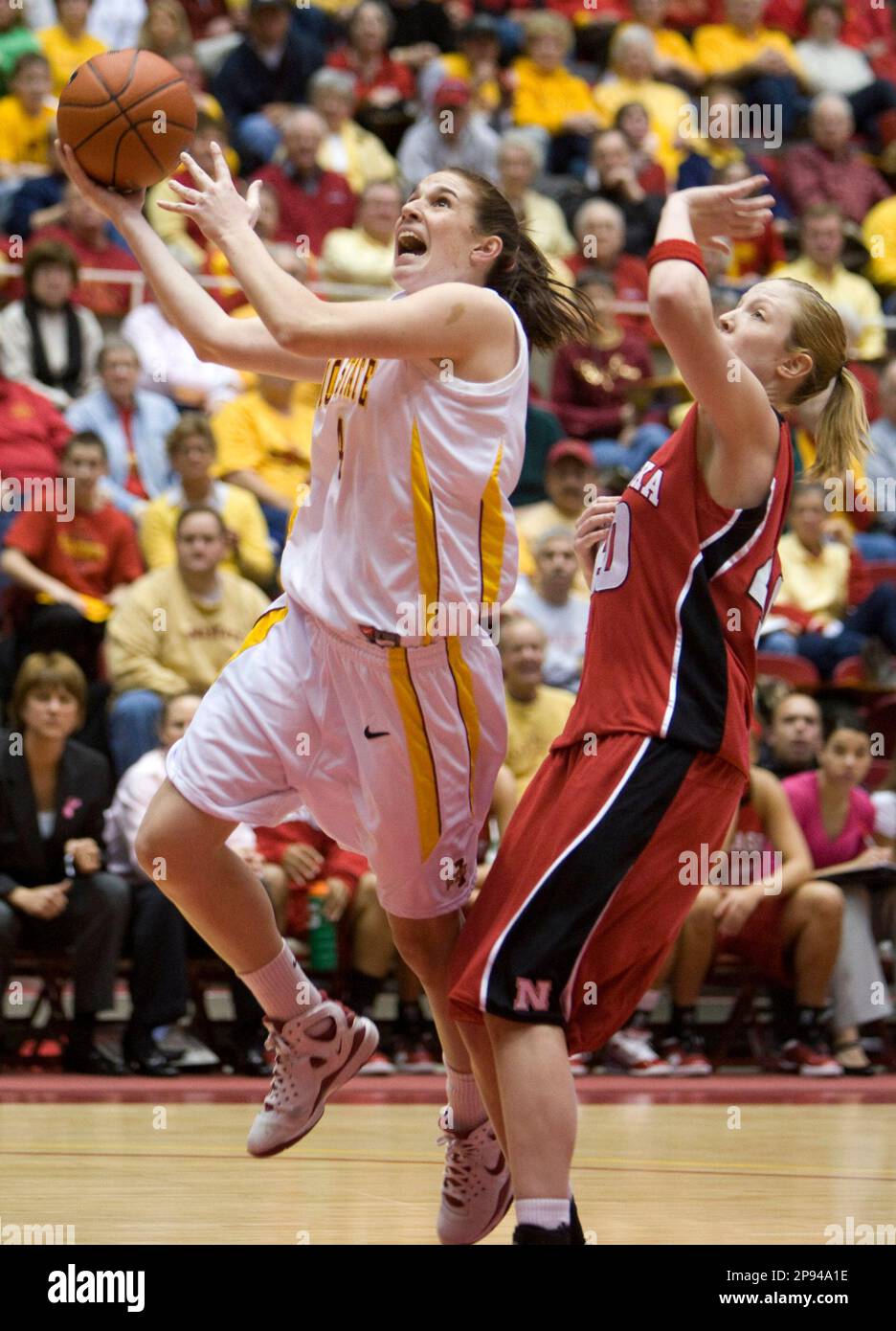 Iowa State's Alison Lacey, left, drives to the basket past Nebraska's ...