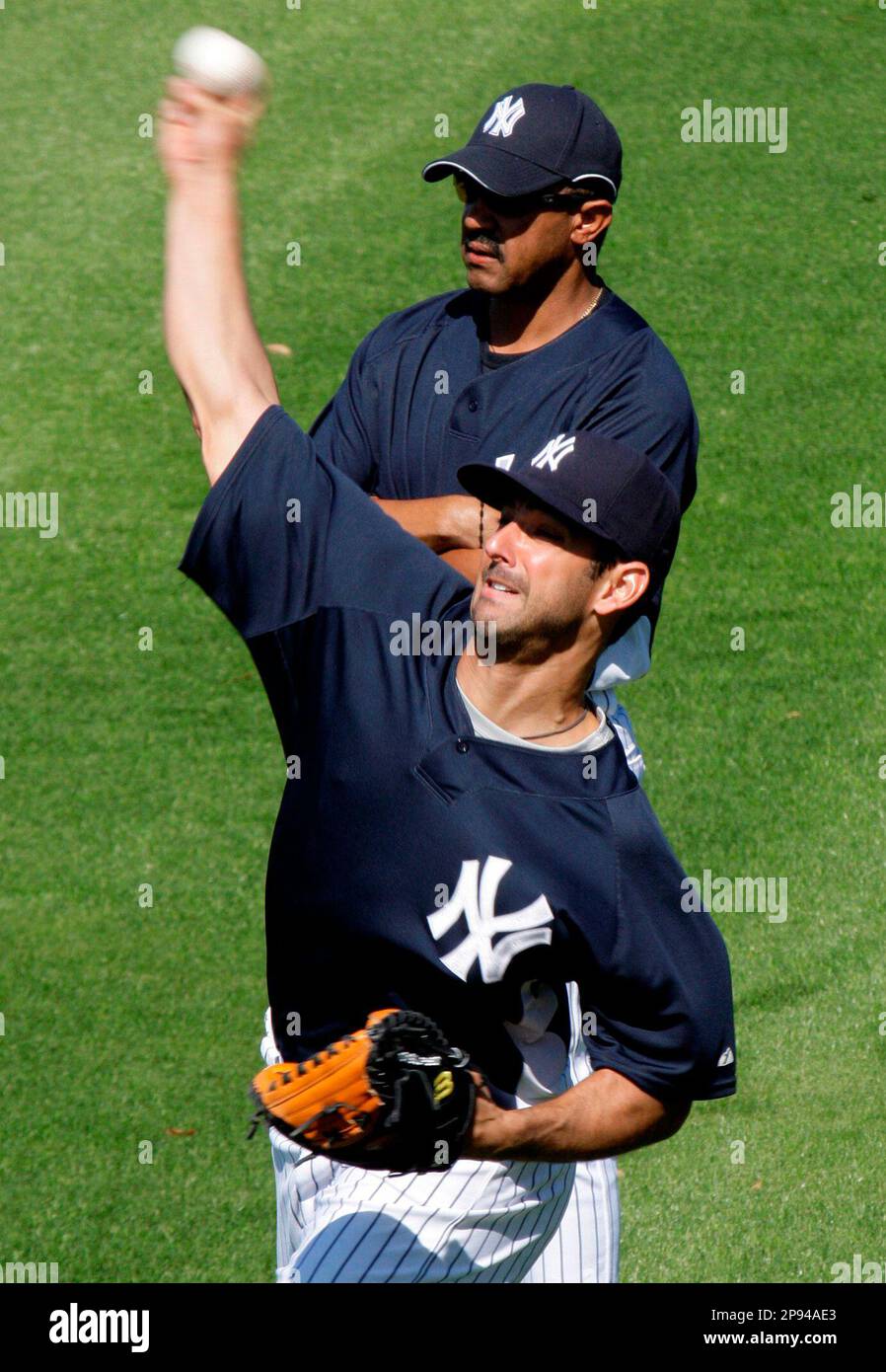 New York Yankees catcher Jorge Posada, bottom, long-tosses as coach ...