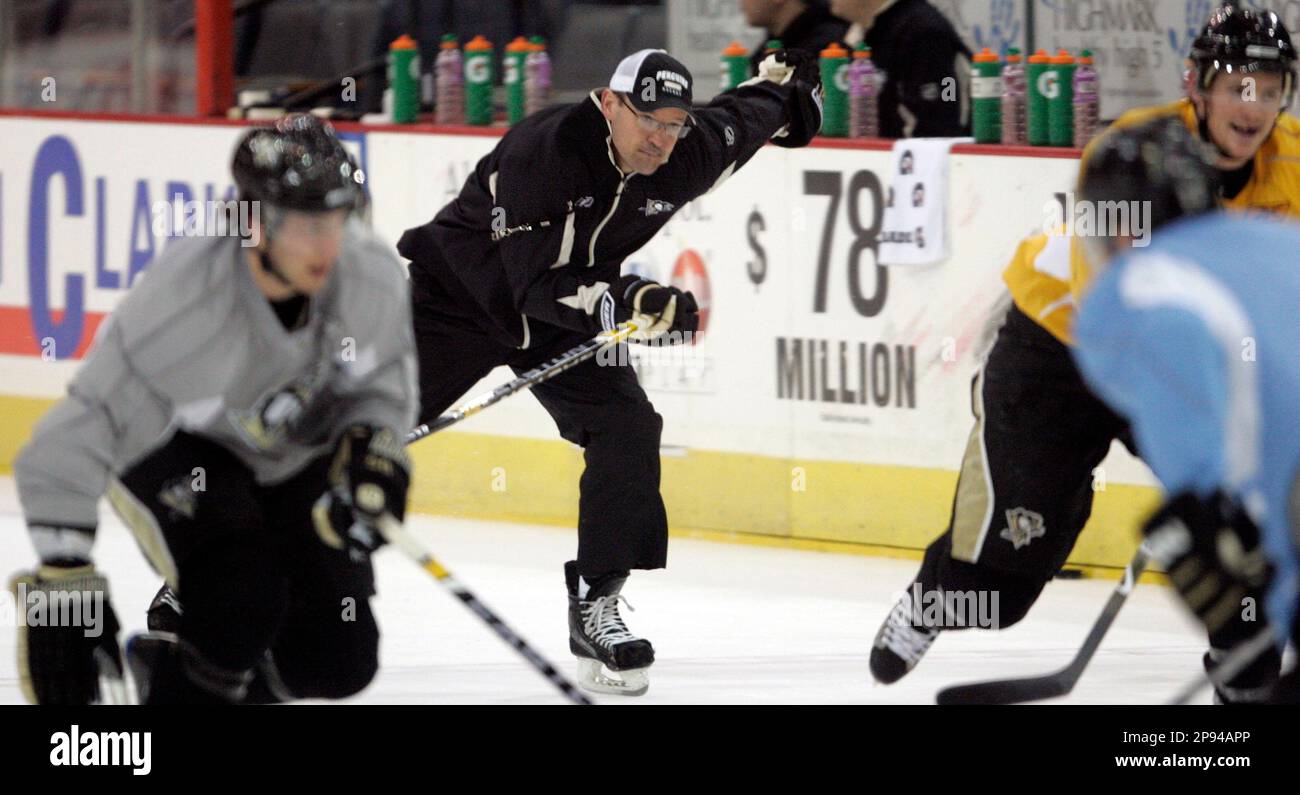 Pittsburgh Penguins new interim coach Dan Bylsma, center, skates with ...